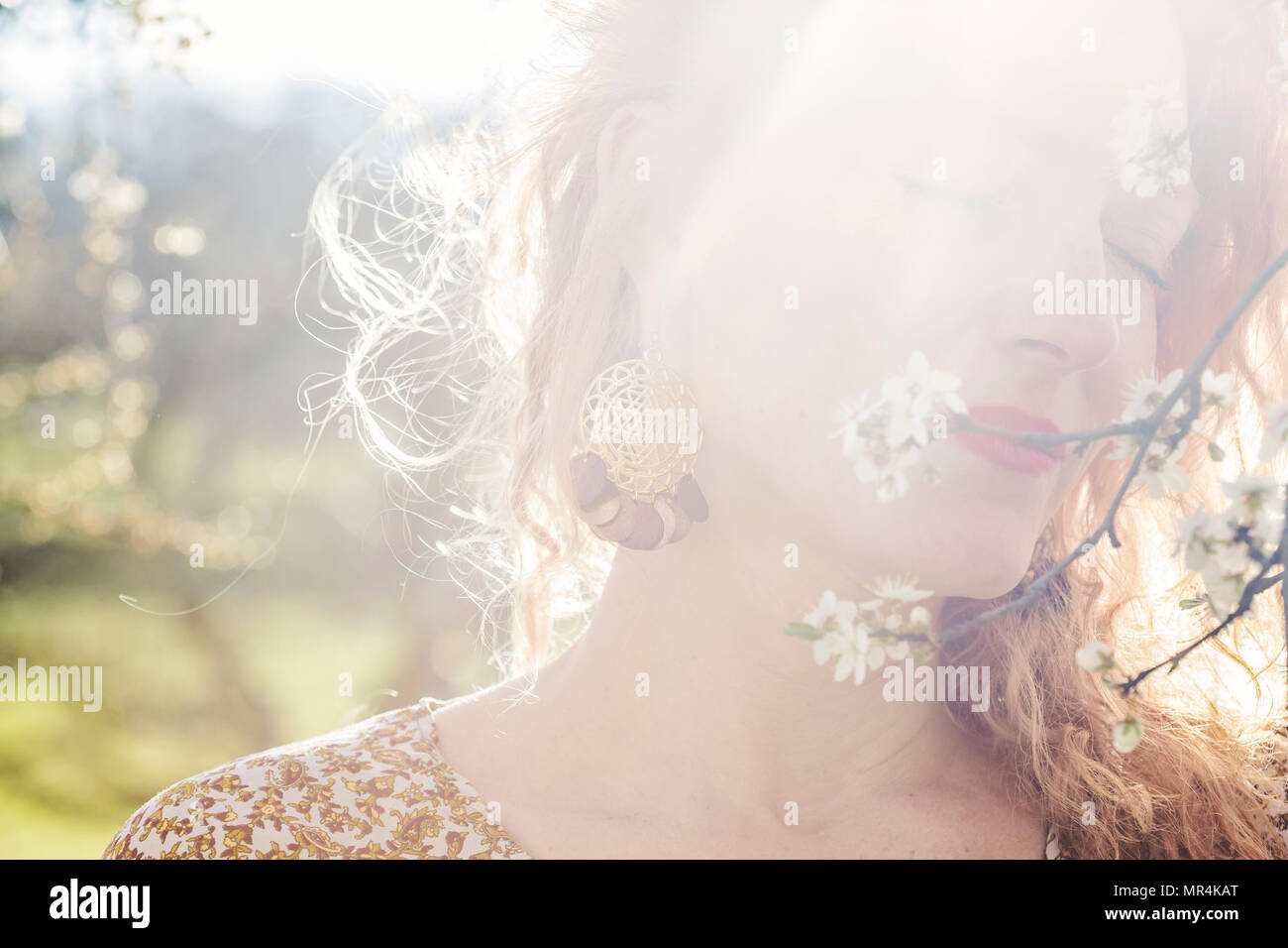Beautiful woman in spring light garden Stock Photo - Alamy