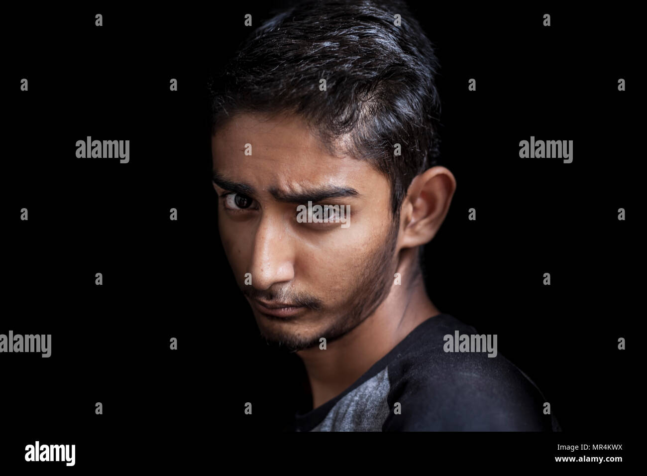 Portrait of a young teenager annoyed or angered on some thing poses in ...