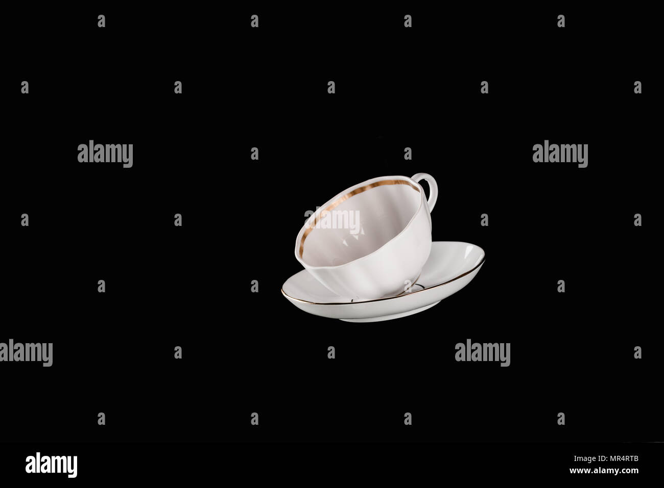 white cup and plate isolated on black Stock Photo - Alamy