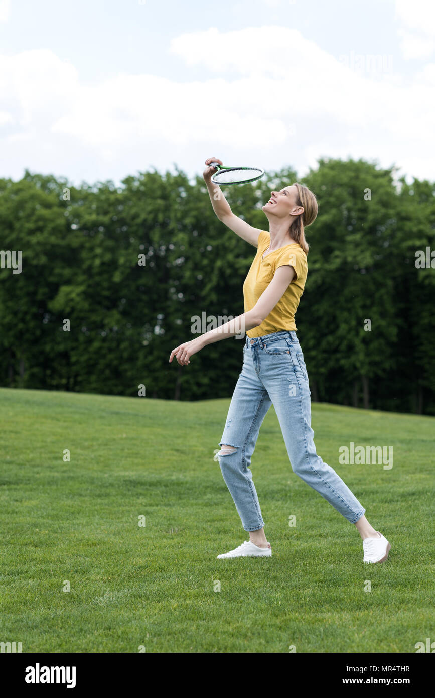 happy active woman playing badminton game in park, summertime concept ...