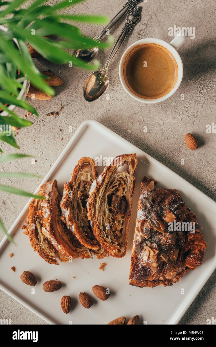 top view of cup of coffee and sweet pastry with almonds on plate Stock ...