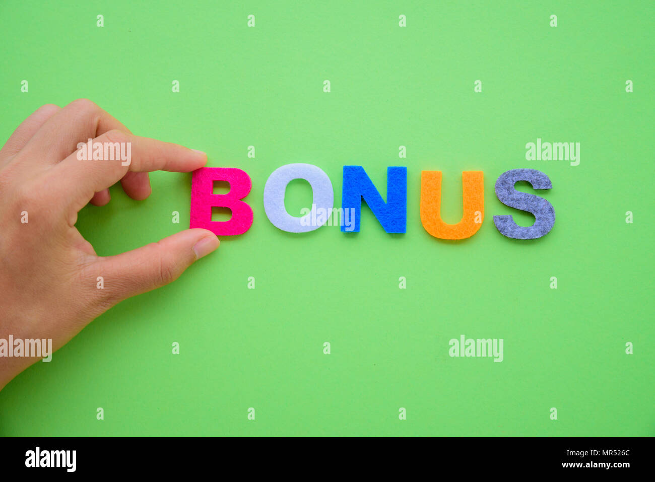 Abstract hand arrange BONUS alphabets word on green background ...