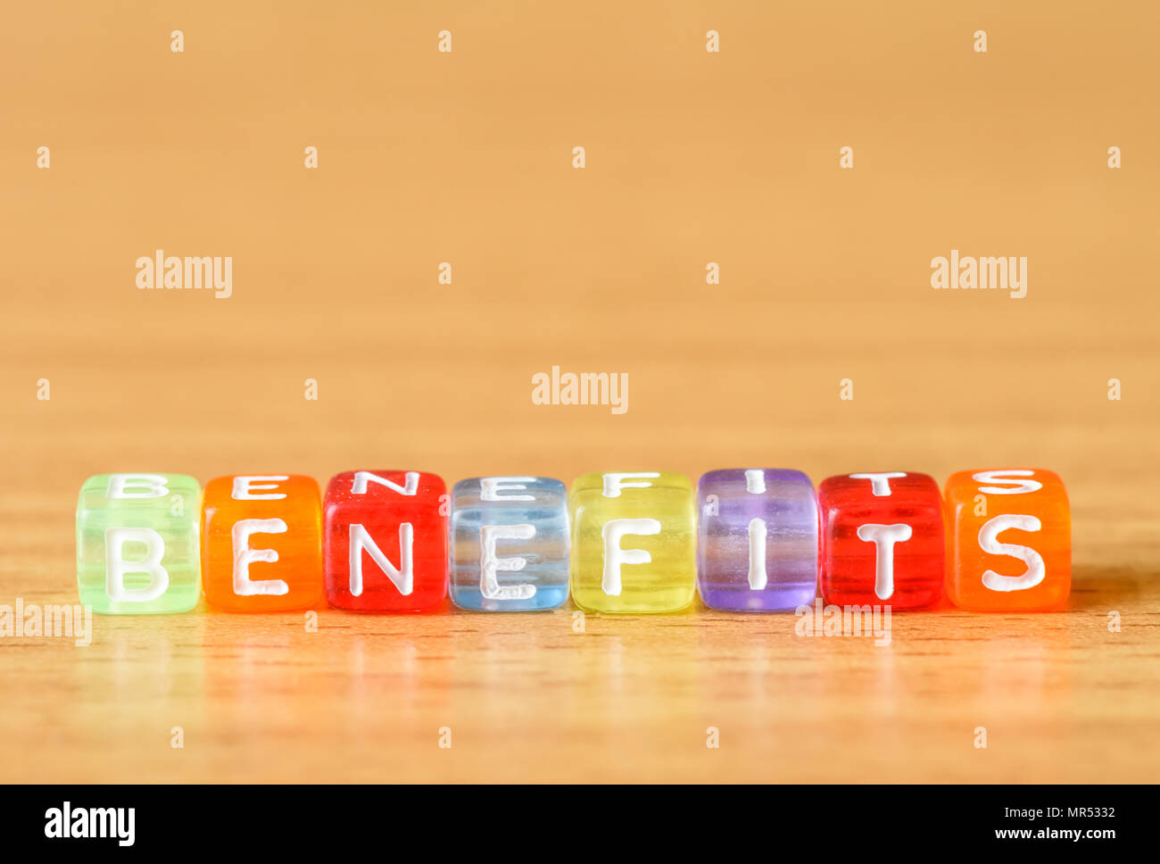 BENEFITS word made from different colors building block on table ...