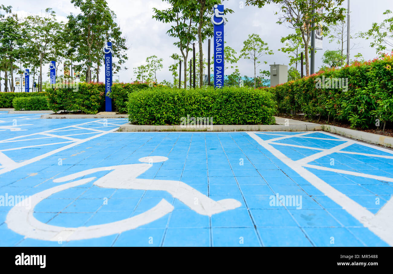 Blue disabled parking sign in the car park area Stock Photo - Alamy