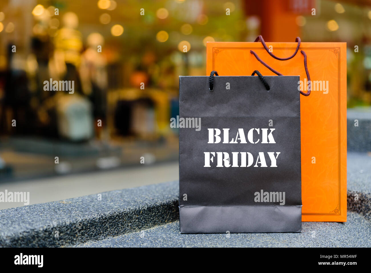 Shopping bags with Black Friday words concpt againts shopping mall ...
