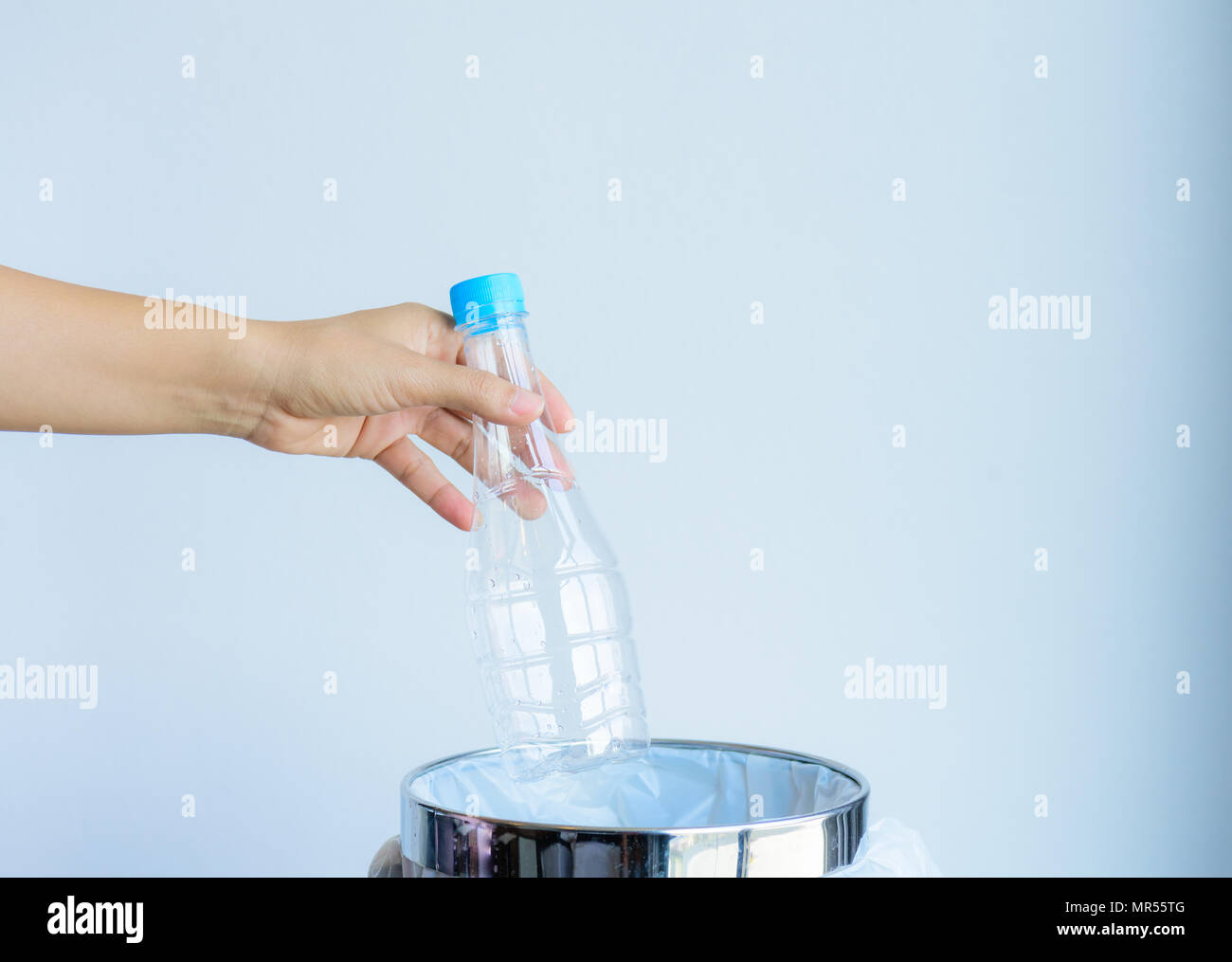 Women hand throwing empty plastic bottle into a trashbin Stock Photo ...