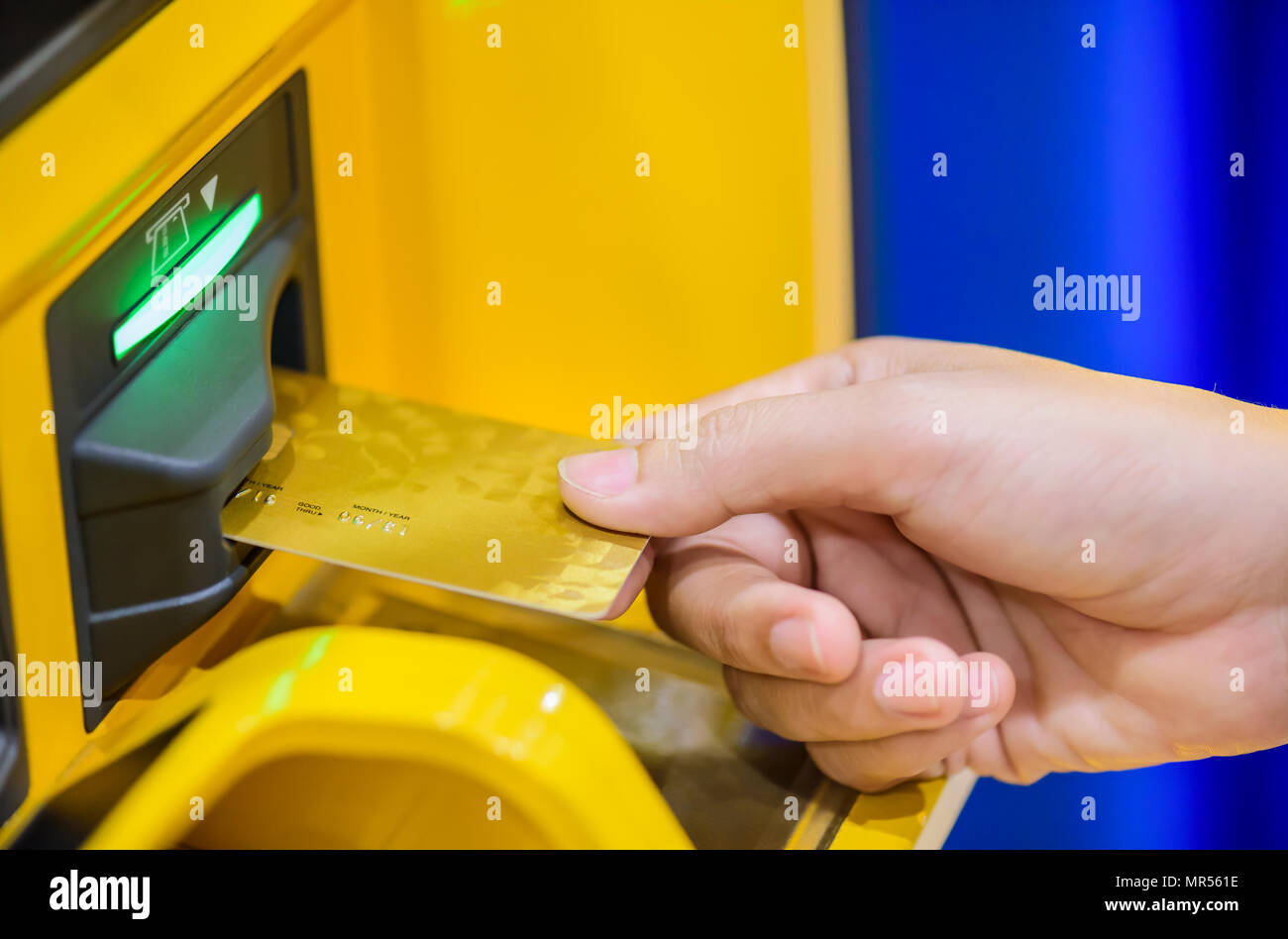 Closeup woman hand inserting debit card into an ATM machine Stock Photo ...