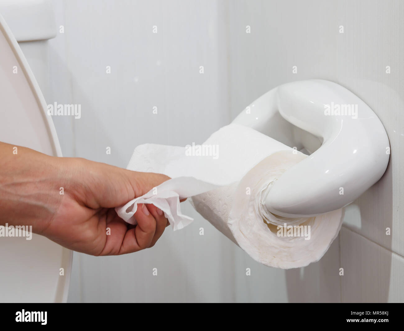 Soft focus woman hand picking a white tissue from tissue roll in the ...