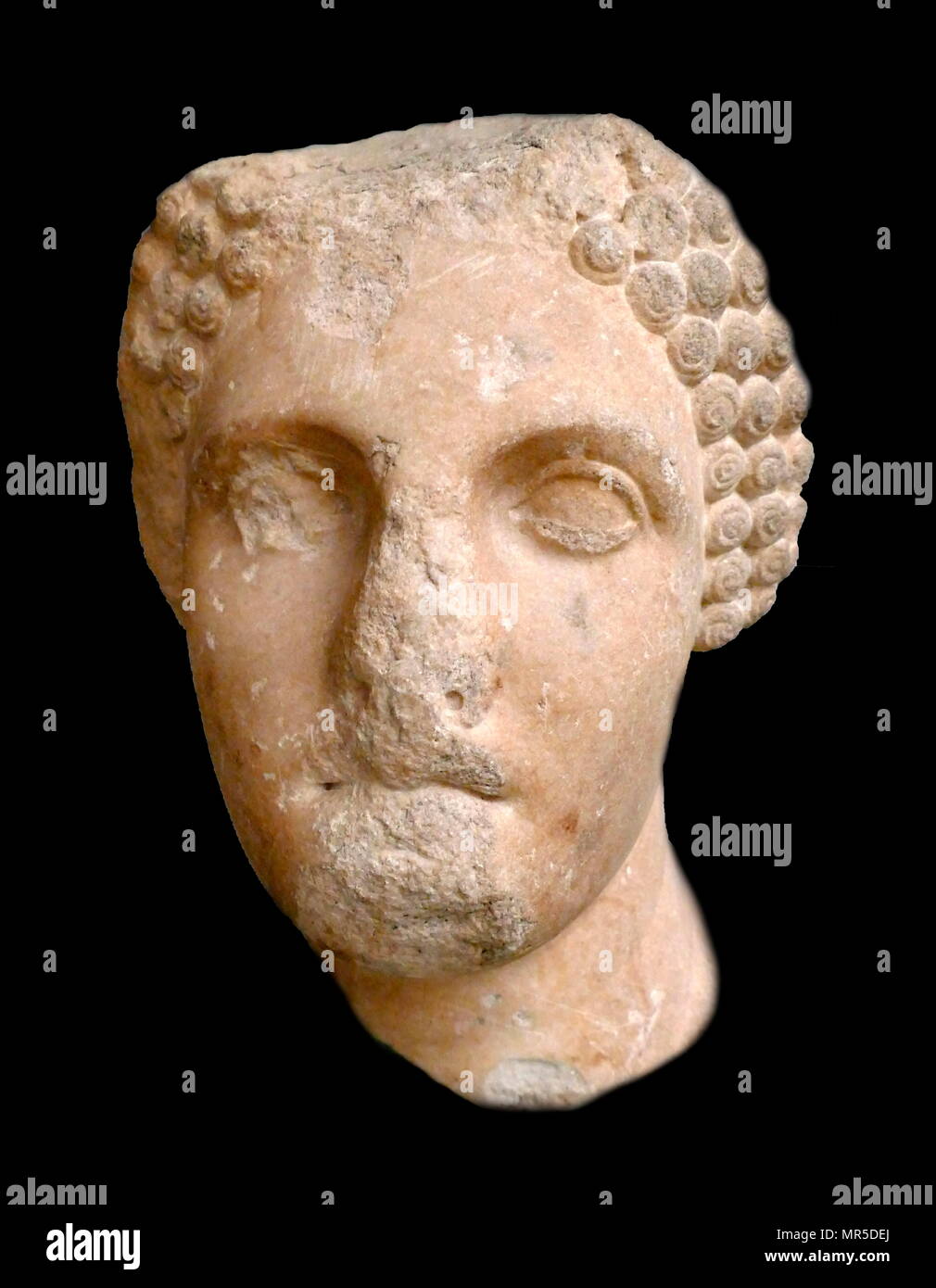 Head from a colossal statue of a woman wearing a sakkos (cap). Parían ...