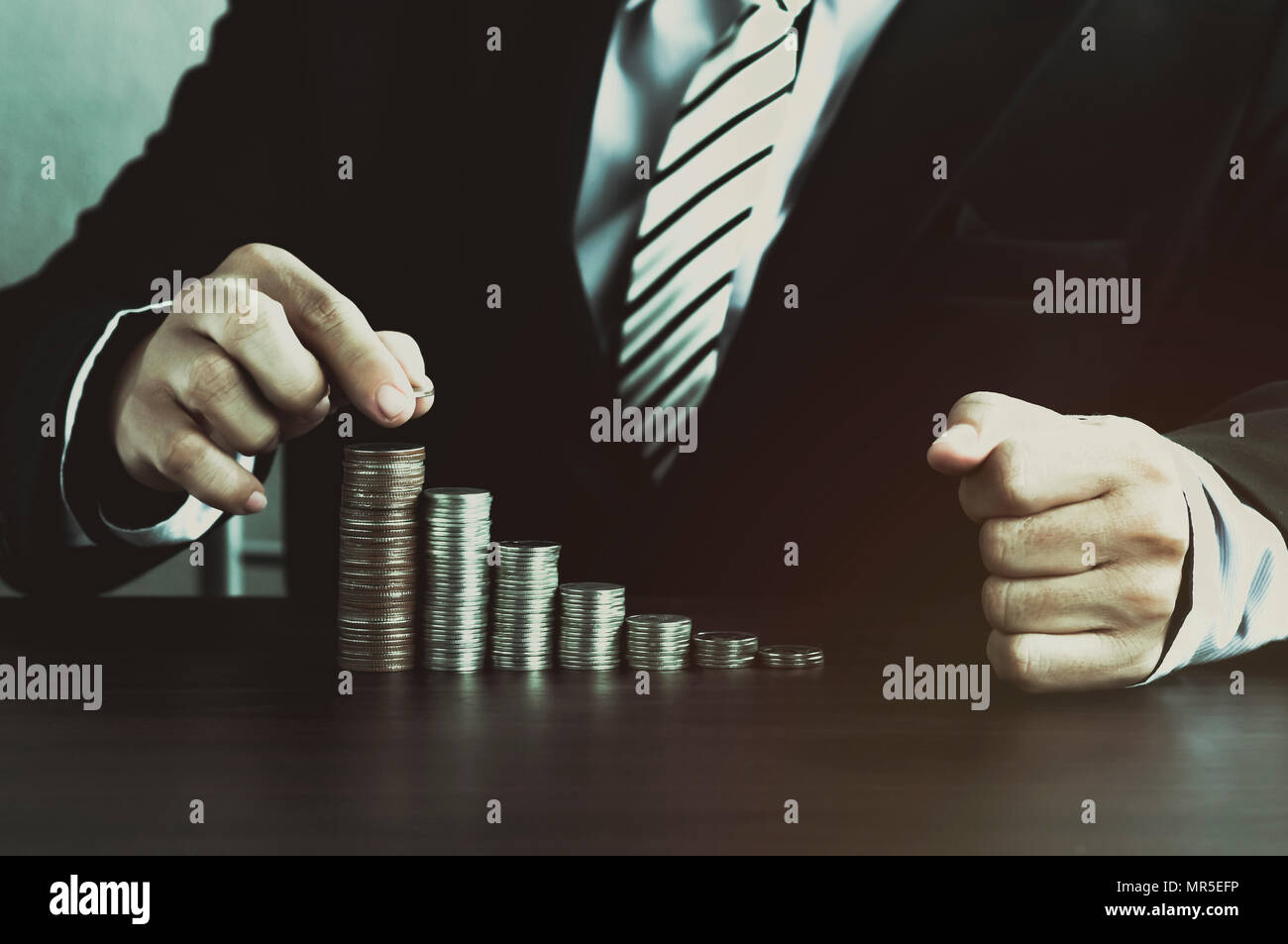 hand of businessman staced on money coins in vintage style Stock Photo ...
