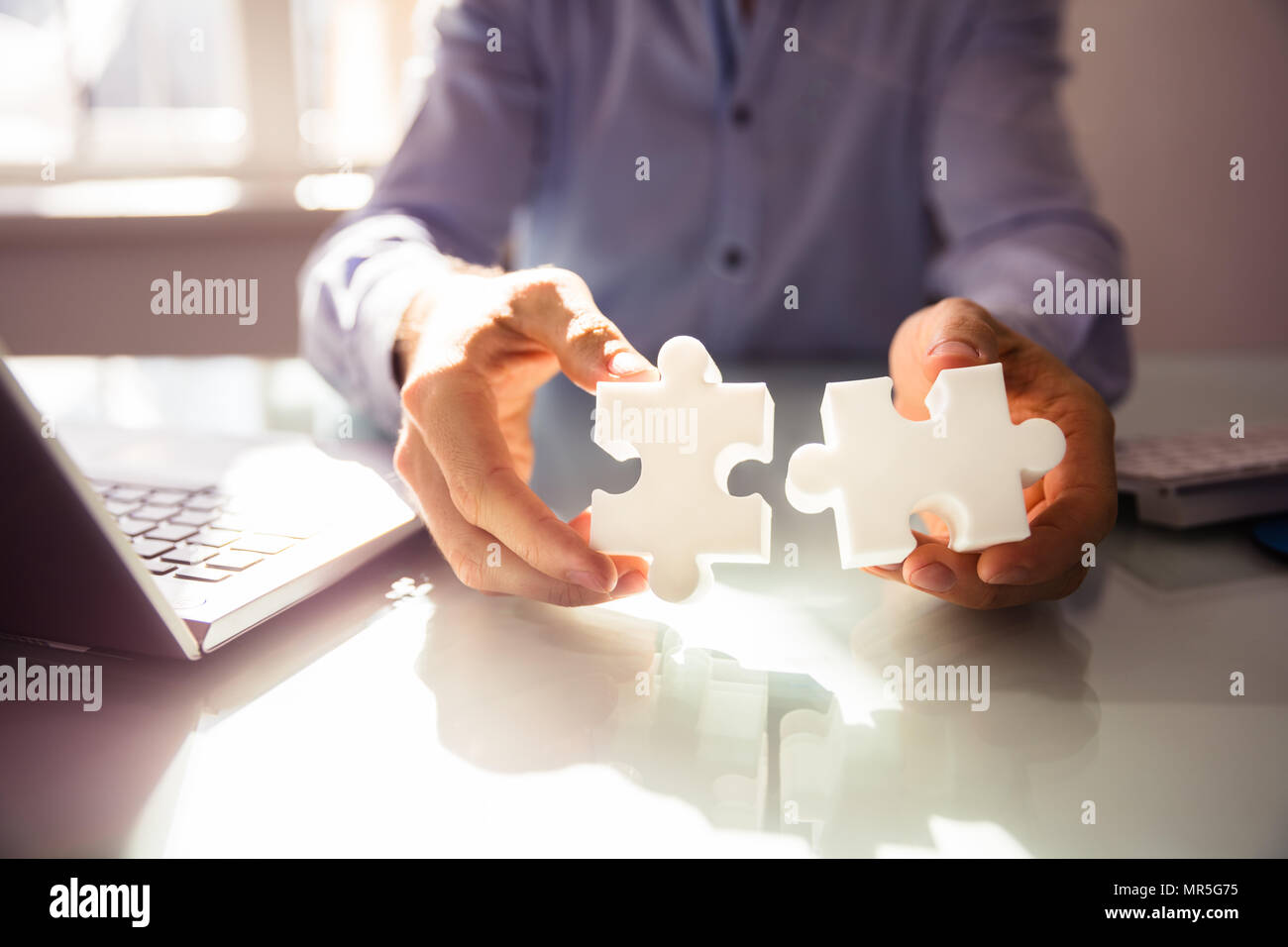 Close-up Of Businessperson's Hand Holding Two White Jigsaw Puzzle Over ...