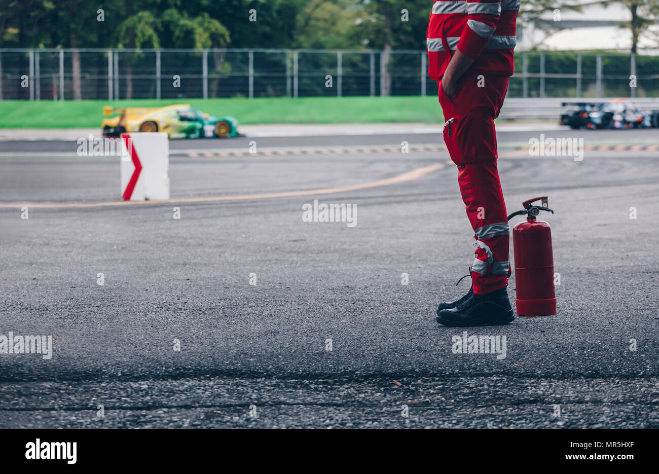 Race marshall stand guard of the safety crew ready to rescue in case of ...