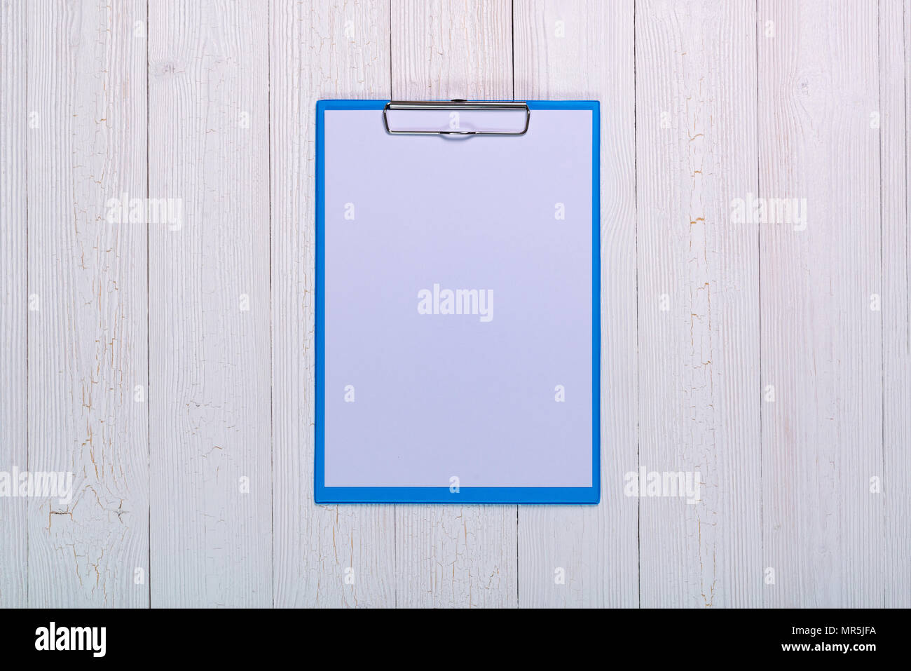 clipboard with blank white paper sheet on wood table top view with copy ...