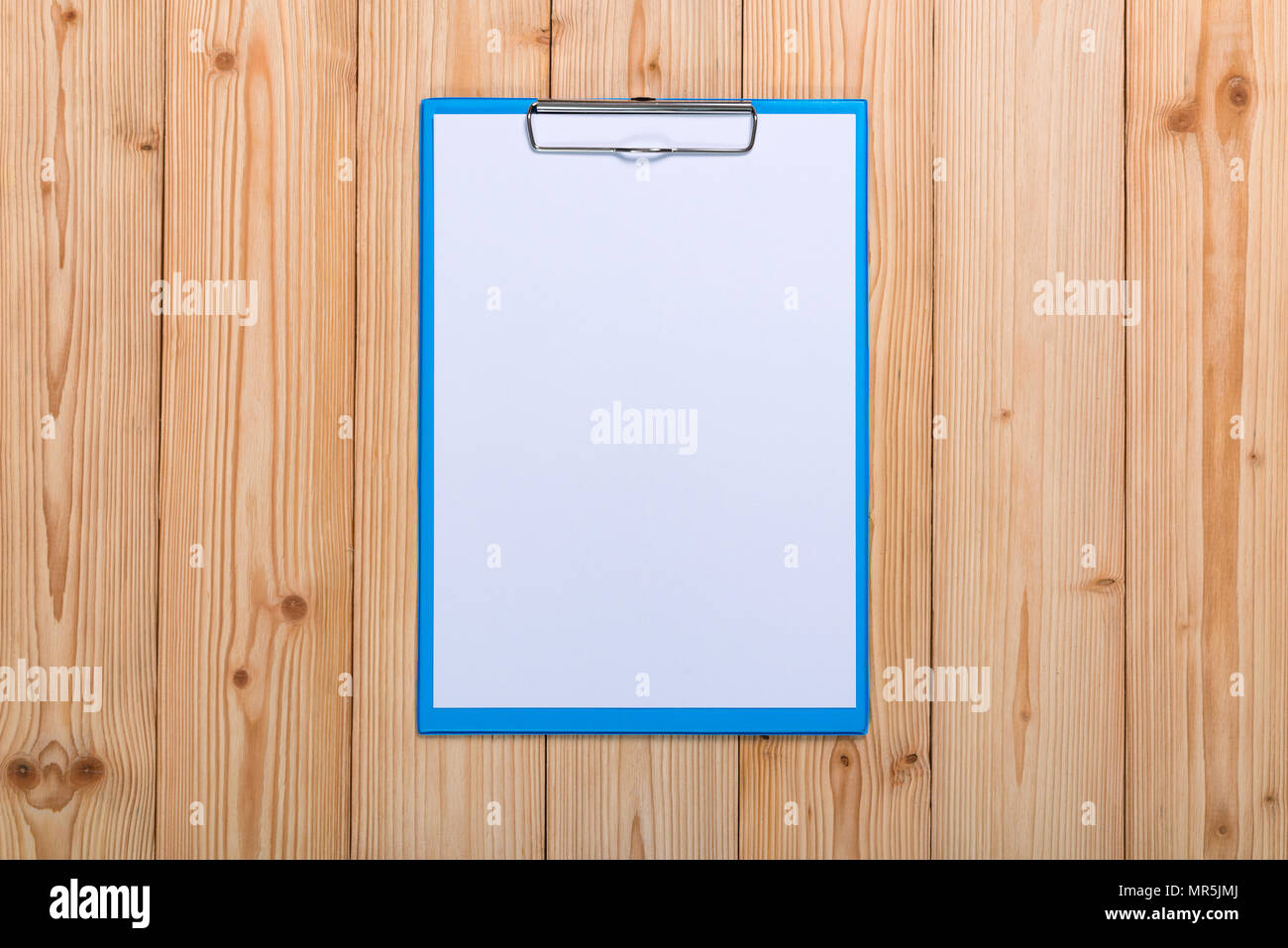 clipboard with blank white paper sheet on wood table top view with copy ...