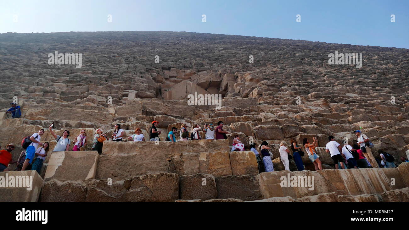 Tourist climb to enter the Great Pyramid of Giza (Pyramid of Khufu or ...