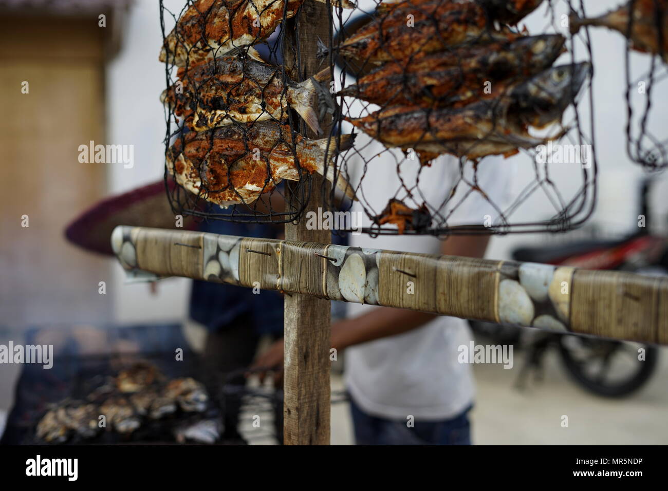 Food vendor cooks and sells Barbecue Grill fish at the street market in ...