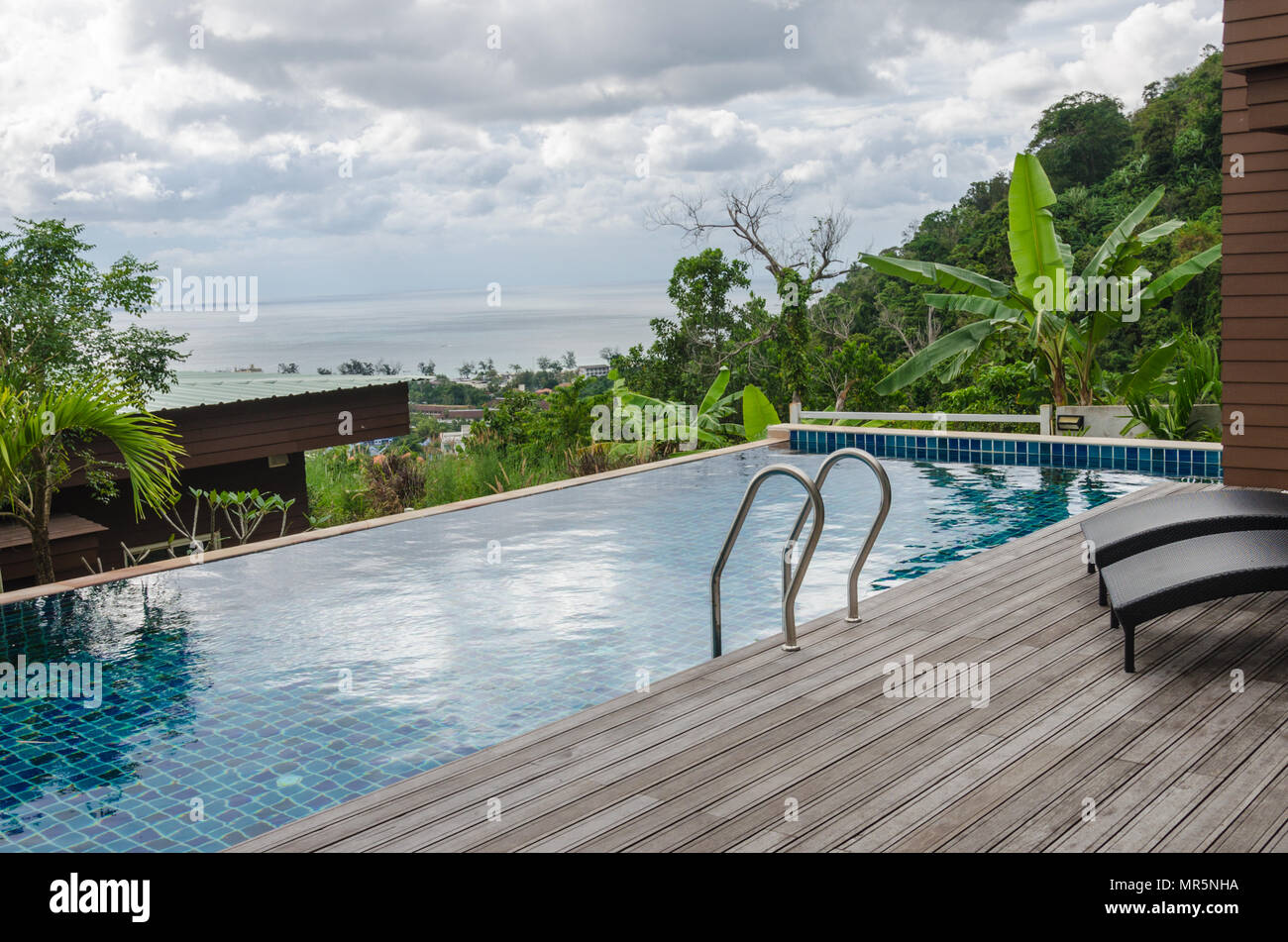 Swimming pool beautiful in tropical resort Stock Photo - Alamy