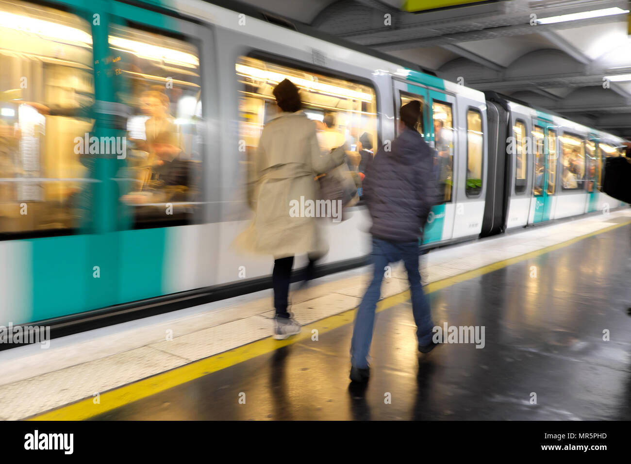 Passengers and underground train on the platform at Pont-Neuf metro ...