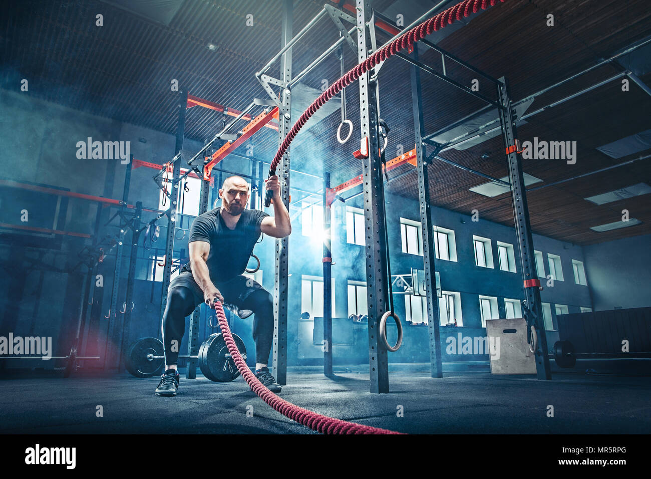 Men with battle rope battle ropes exercise in the fitness gym Stock ...