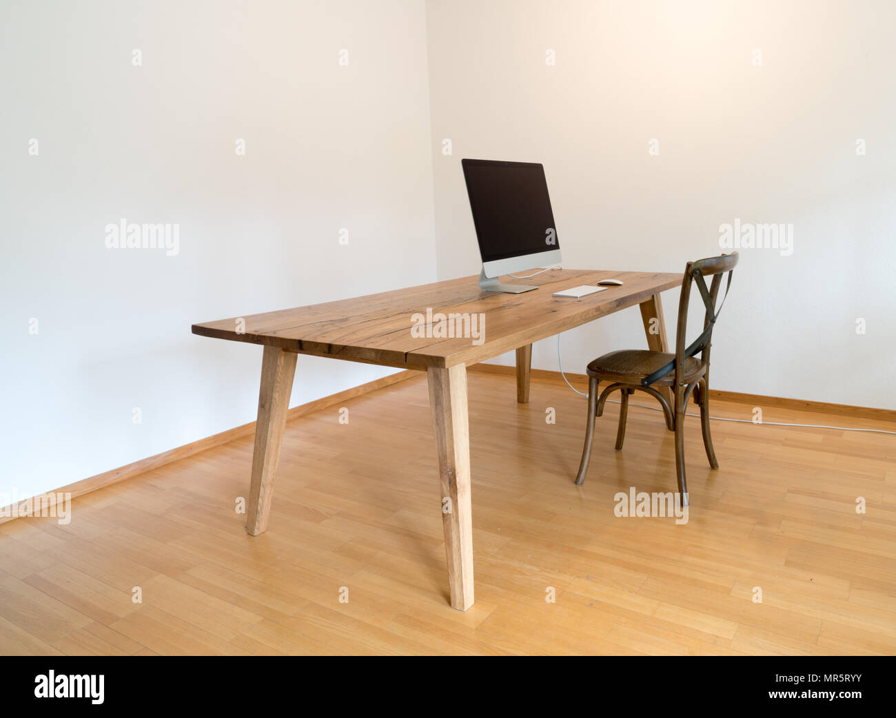 minimalist office with table and chair and computer Stock Photo - Alamy