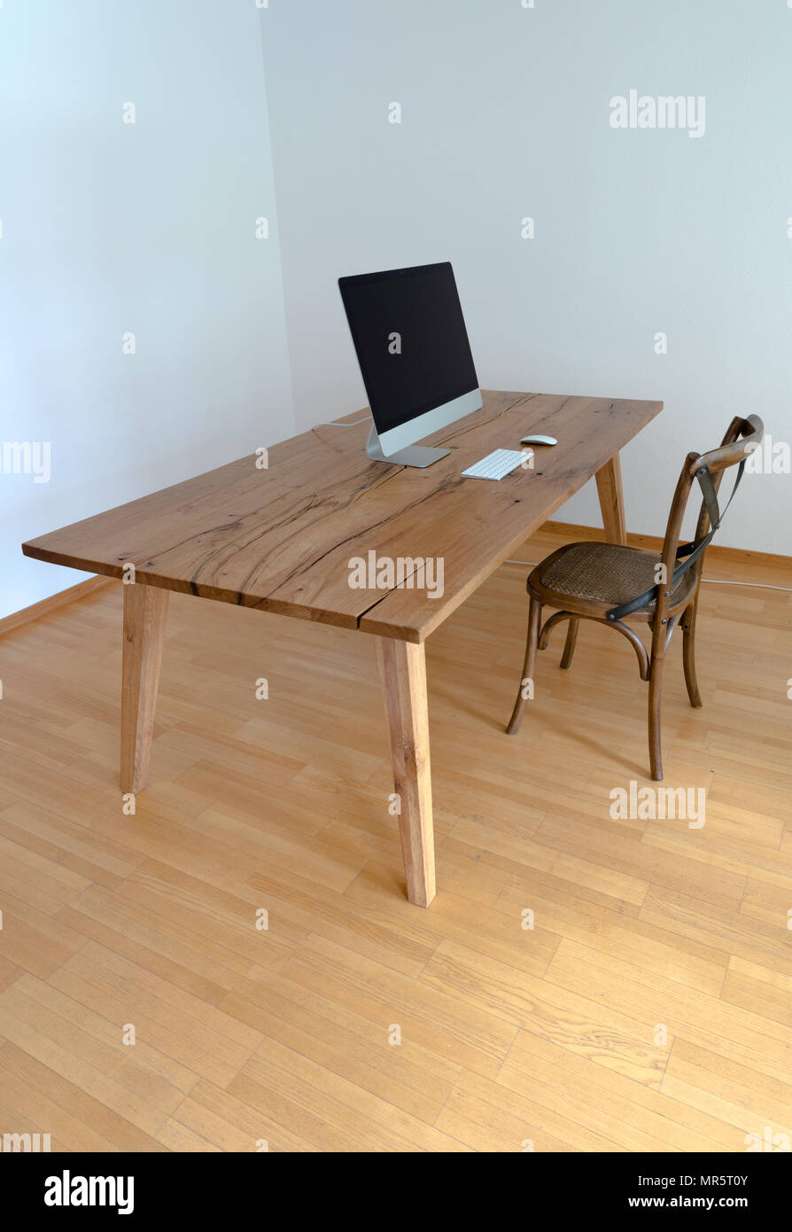 minimalist office with table and chair and computer Stock Photo - Alamy