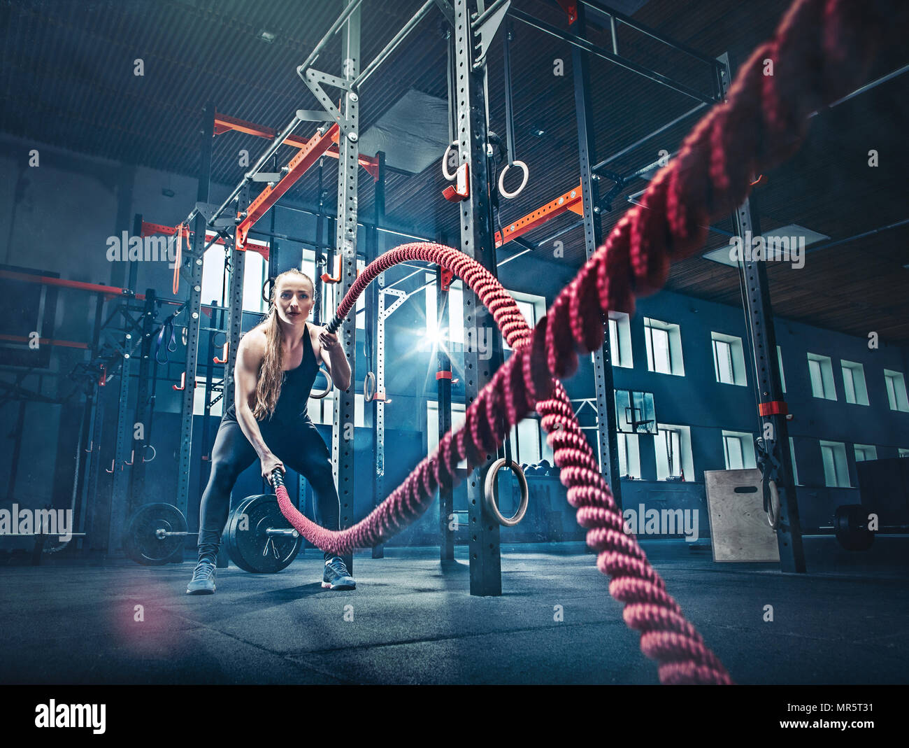 Woman with battle rope battle ropes exercise in the fitness gym Stock ...
