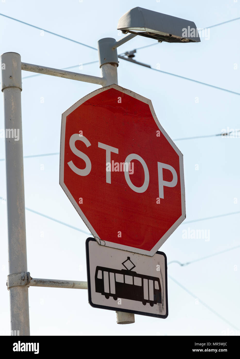 Tramway sign saying stop, with picture of tram, overhead tramlines in ...