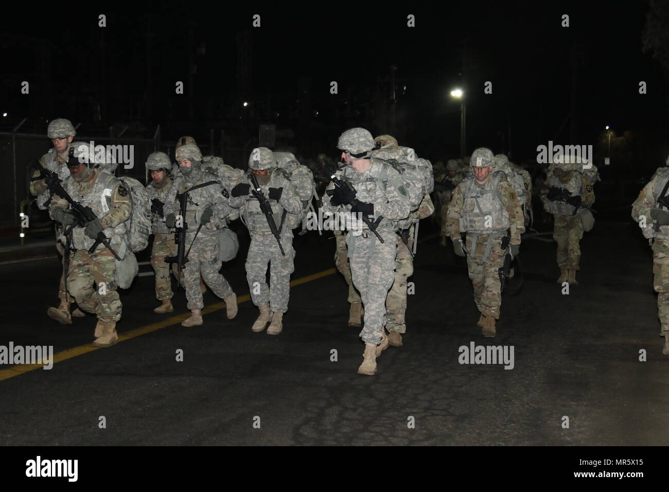 Soldiers of 210th Field Artillery Brigade conduct a ruck march during ...