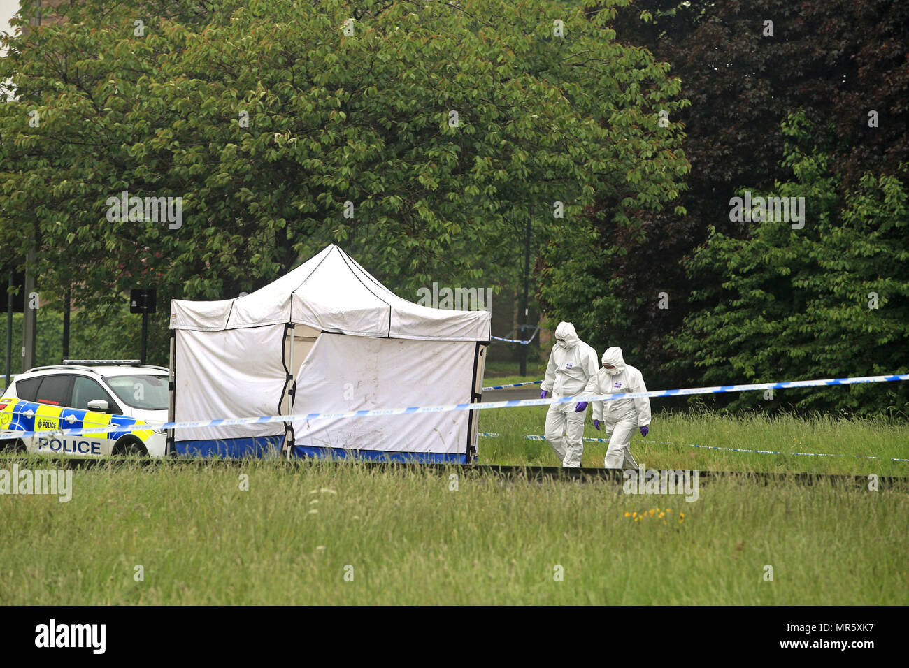 Forensic officers at the scene in Lowedges Road in Sheffield, South Yorkshire, where a murder ...