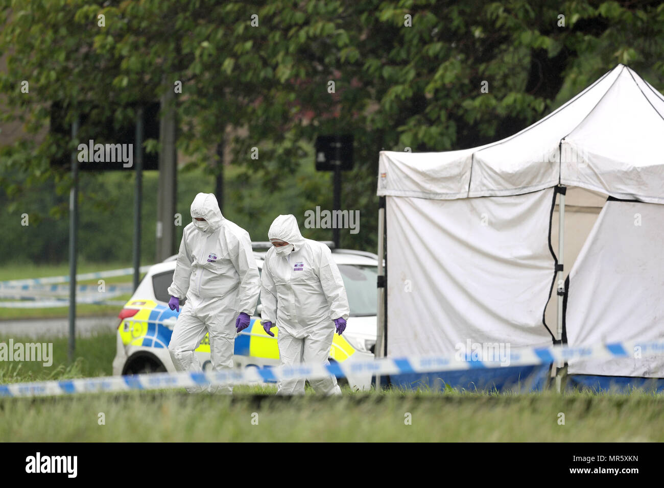 Forensic officers at the scene in Lowedges Road in Sheffield, South Yorkshire, where a murder ...