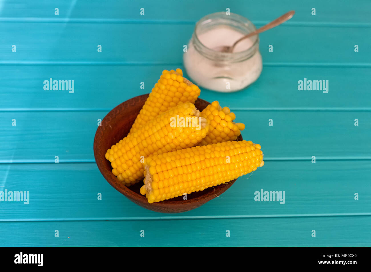Boiled corn on a blue wood background Stock Photo - Alamy