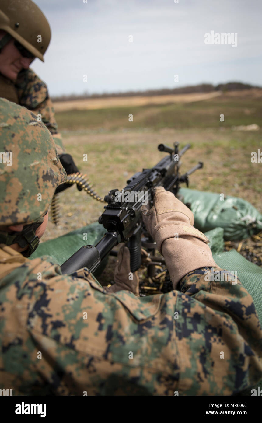 A U.S. Marine with Headquarters and Service Battalion fires the M240B ...