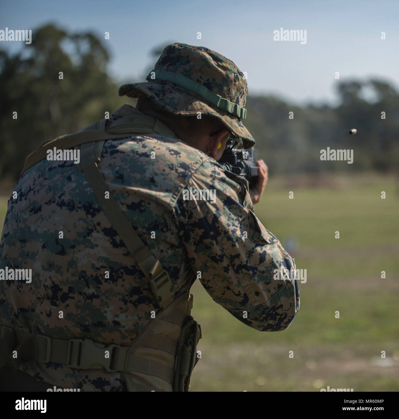 Sgt. Damian Knight fires his M4 service rifle at steel targets, May 16 ...