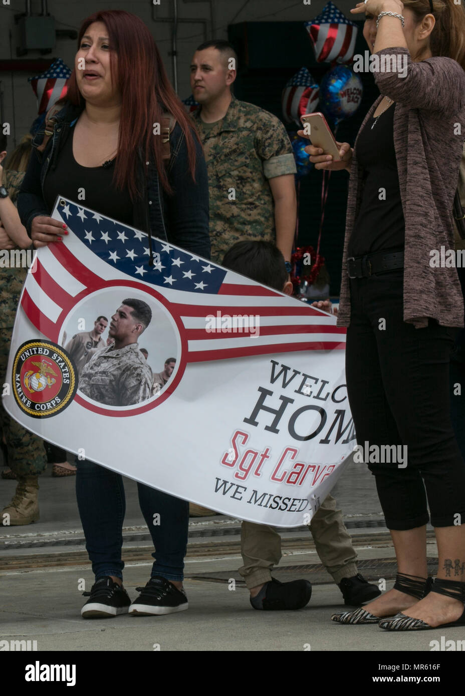 Family members wait for U.S. Marine Corps Sgt. Jose Carvajal, a ...