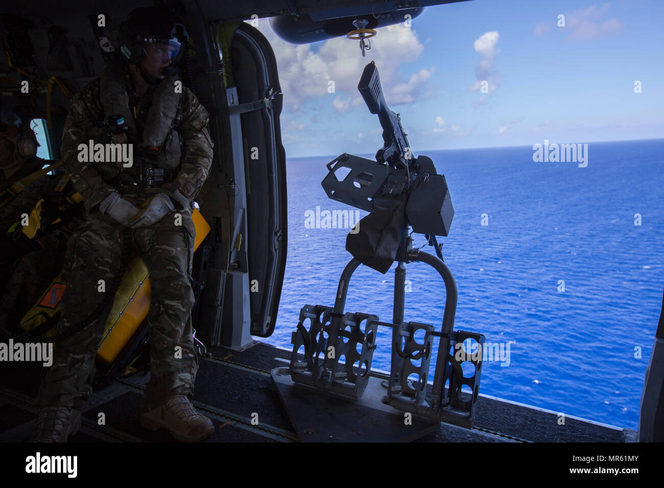 A British MK3 Merlin Crew Chief observes the ocean from above in a ...