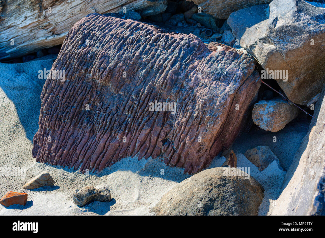 Close up of rocks and wood that are used to build the jetty in ...