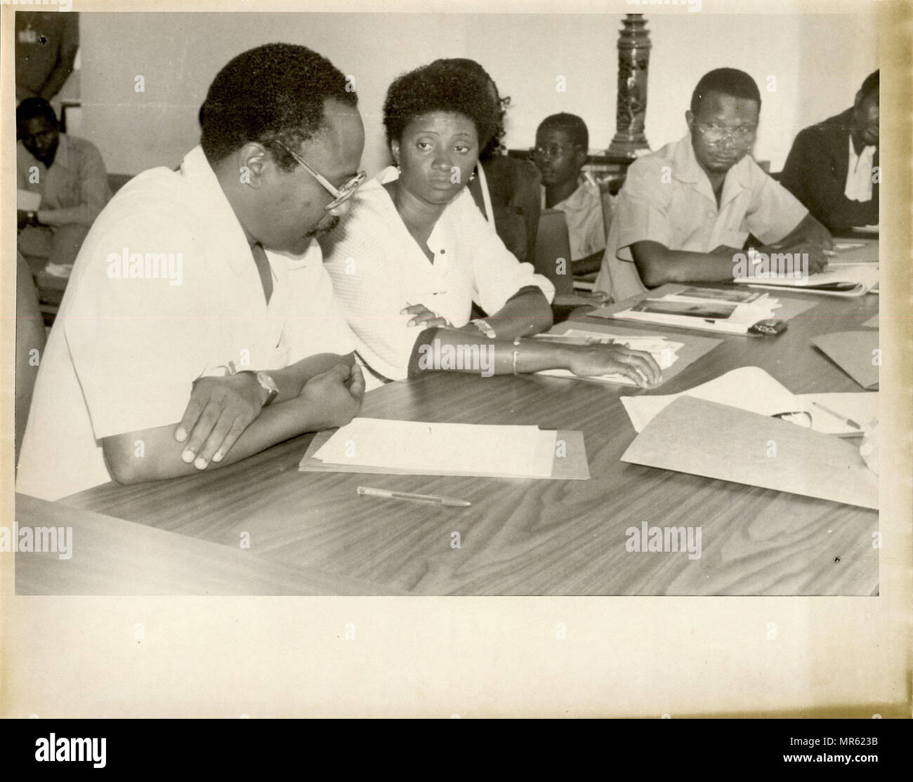 man and woman sitting next to eachother Stock Photo - Alamy
