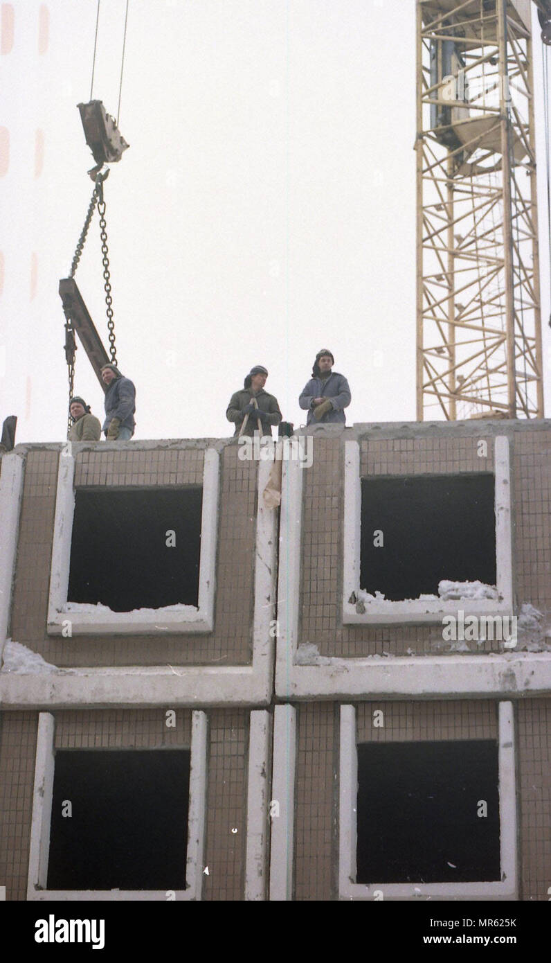 men ontop of building and working Stock Photo - Alamy