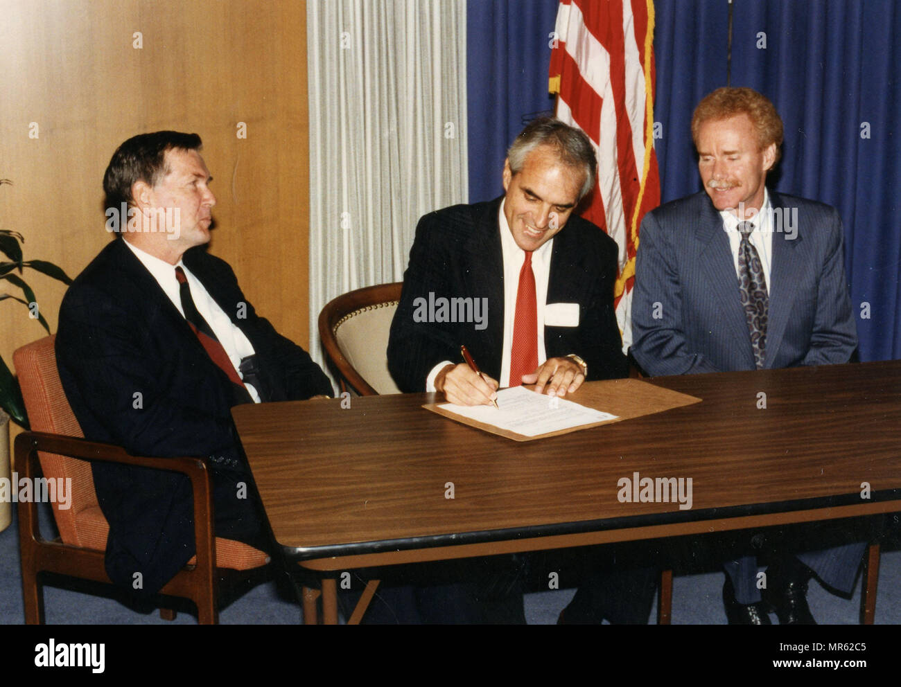 men talking and signing papers Stock Photo - Alamy