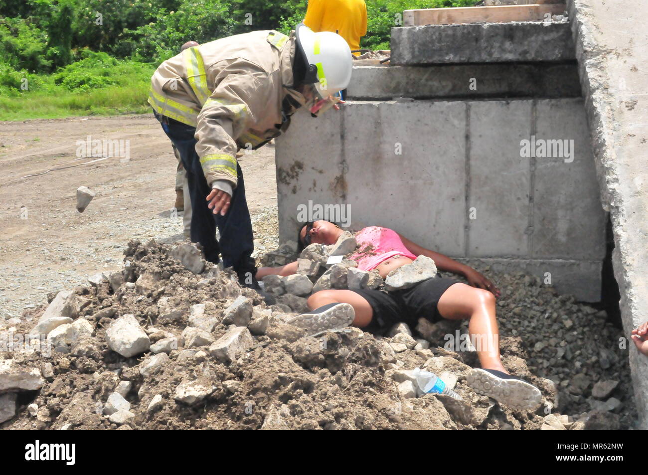 A firefighter from the Virgin Islands Fire Department assists a ...