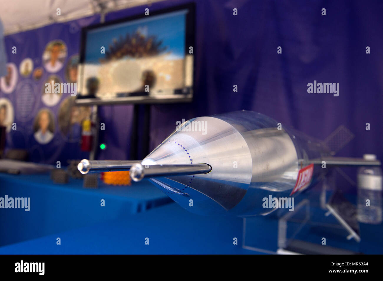 A television shows an explosion behind an Air Force bomb replica during ...