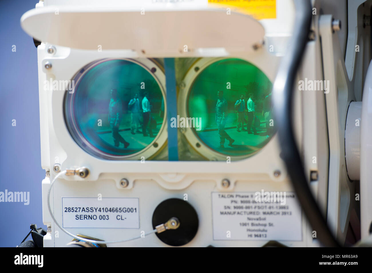 Lenses from an optical data transmission device reflect people ...