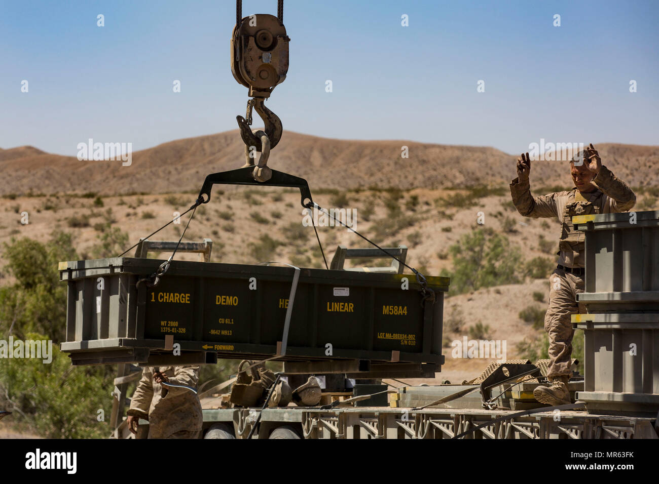U.S. Marines with 1st Combat Engineer Battalion direct a line charge at ...