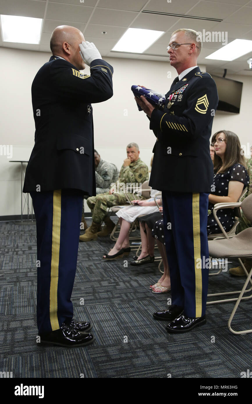 U.S. Army Sgt. 1st Class Sergio Exposito (left) salutes the flag after ...