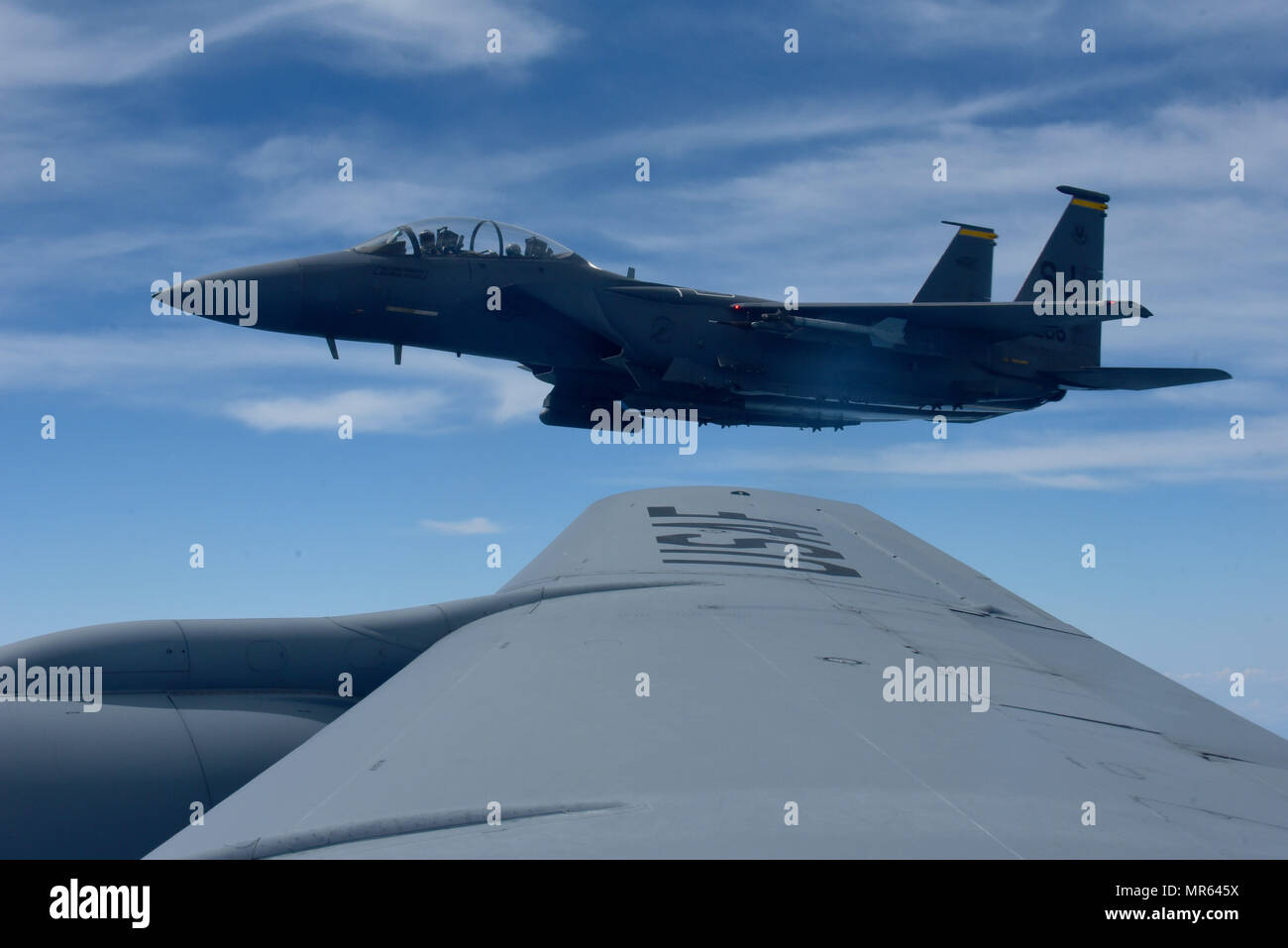 A 336th Fighter Squadron F-15E Strike Eagle flies near a KC-135R Stratotanker, May 18, 2017, in ...