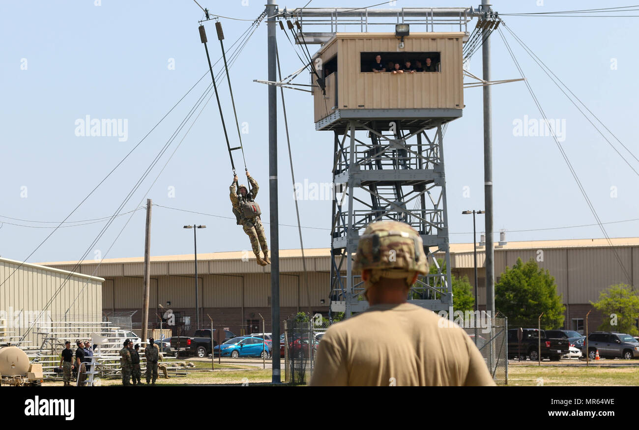 Jump Masters watches as paratroopers jump from the jump tower ...