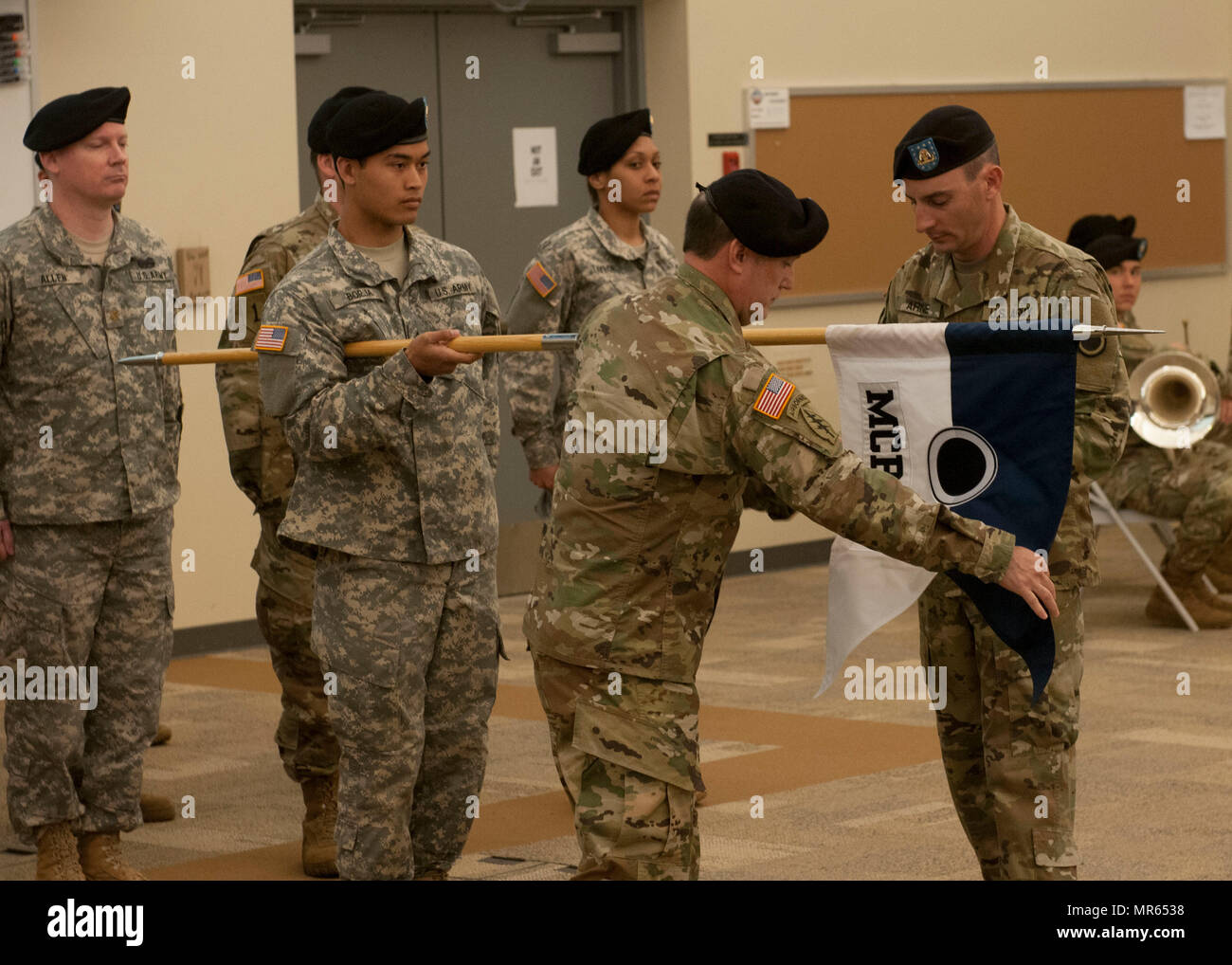 U.S. Army Lt. Col. Erik Flint uncases the colors for the Main Command ...
