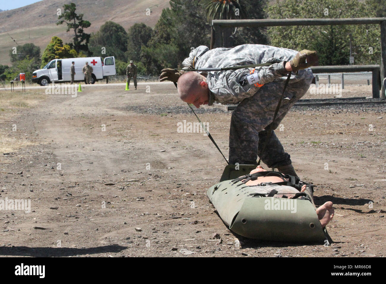 Utah Army National Guardsman Sgt. Peter R. Wiedmeier prepares to drag a ...