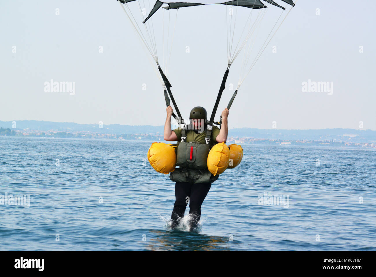 An Italian Army Paratrooper conducts a water jump into Lake Garda near ...