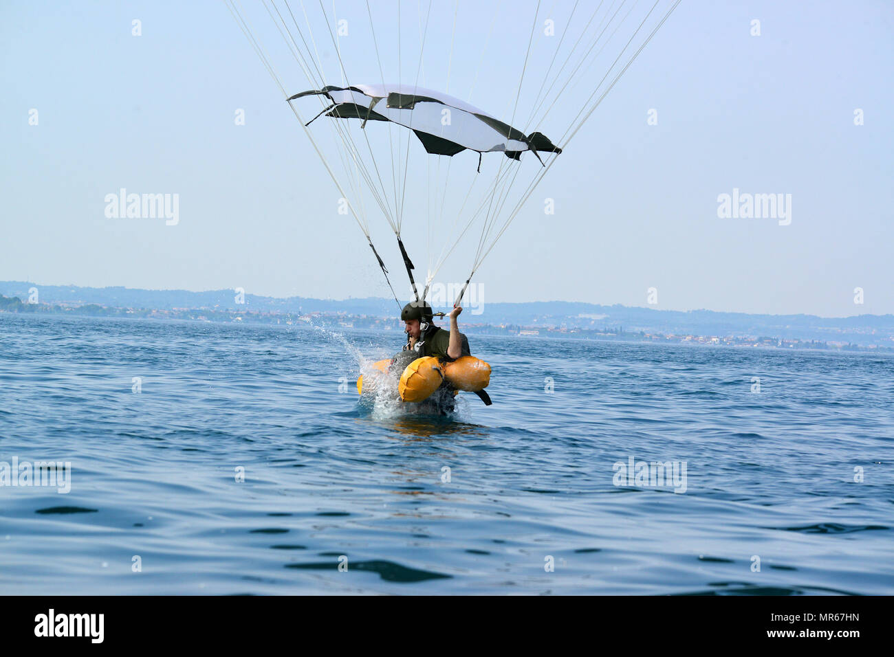 An Italian Army Paratrooper conducts a water jump into Lake Garda near ...